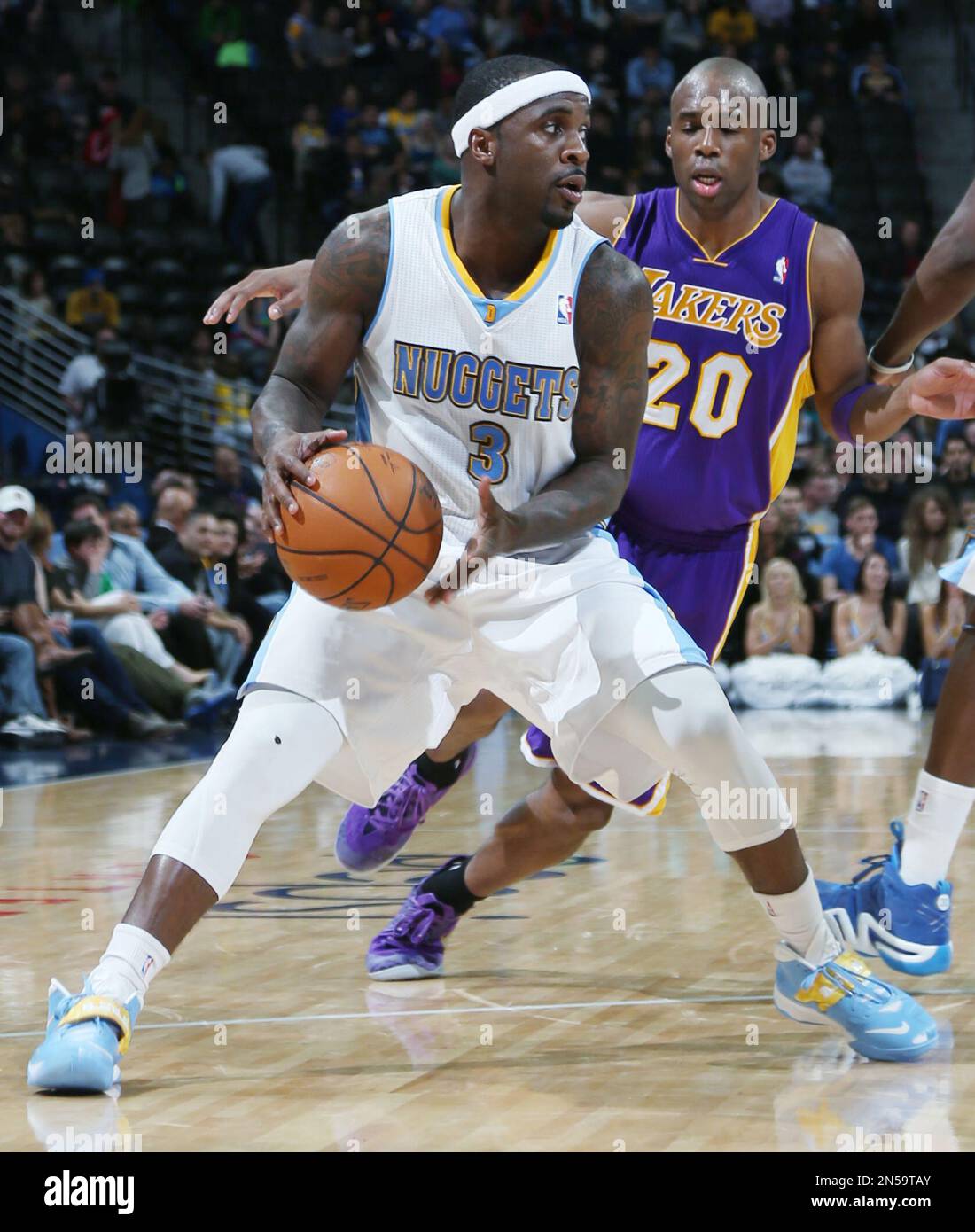 Denver Nuggets guard Ty Lawson, front, looks to pass ball as Los ...