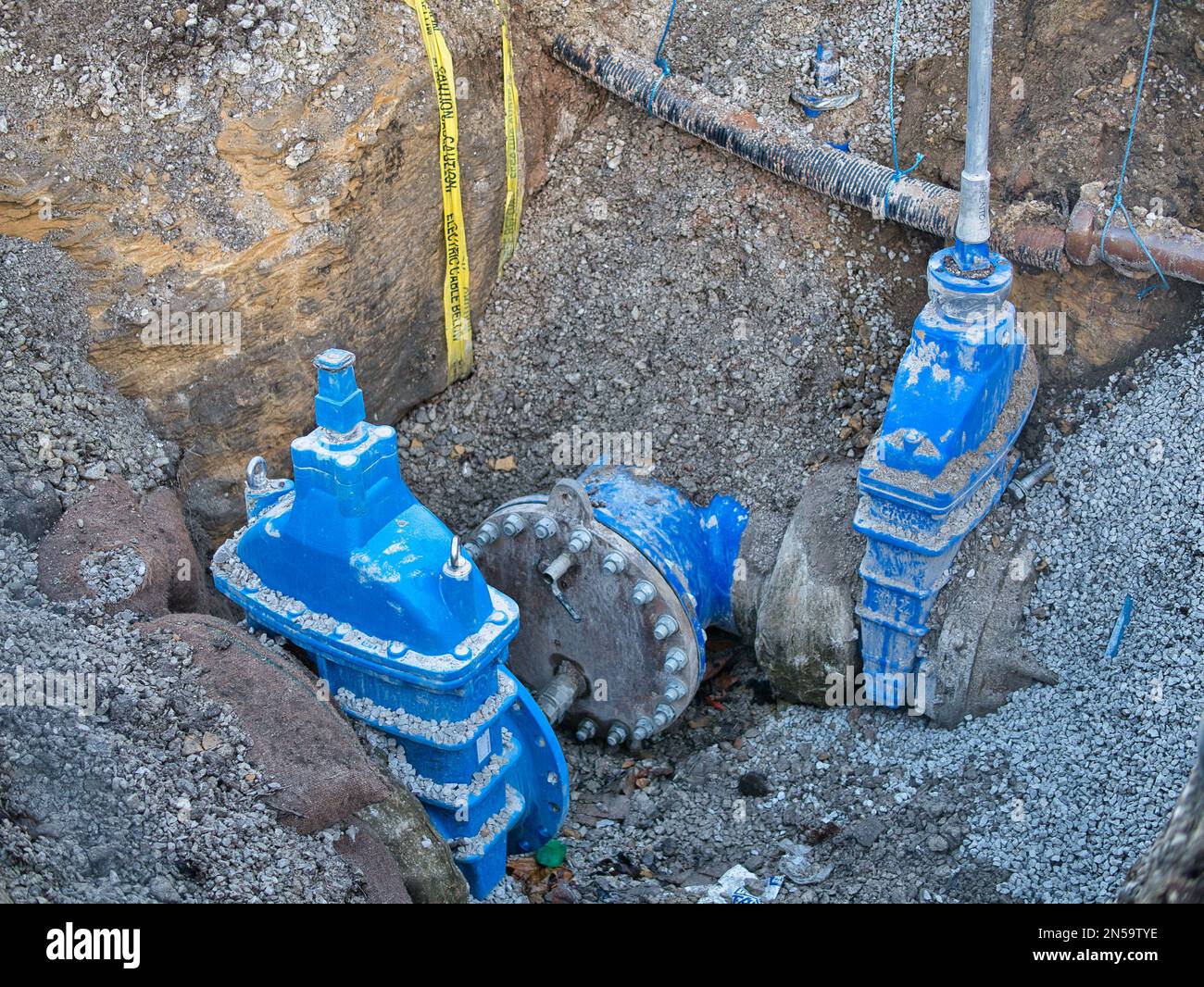 Gate valves in a dug trench in a pavement - part of a water supply ...