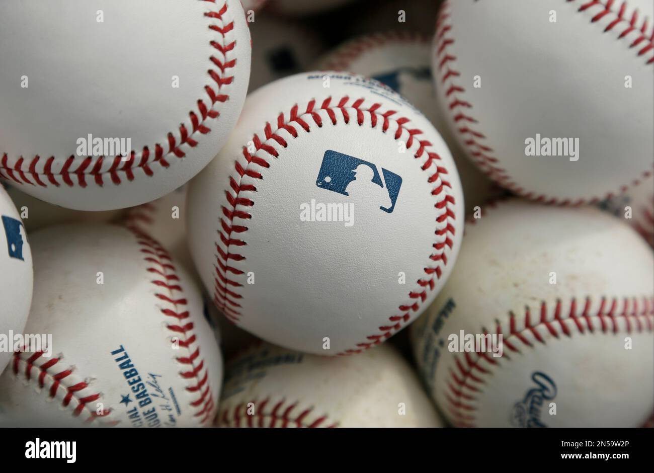 Baseballs sit in a basket before an exhibition baseball game between ...