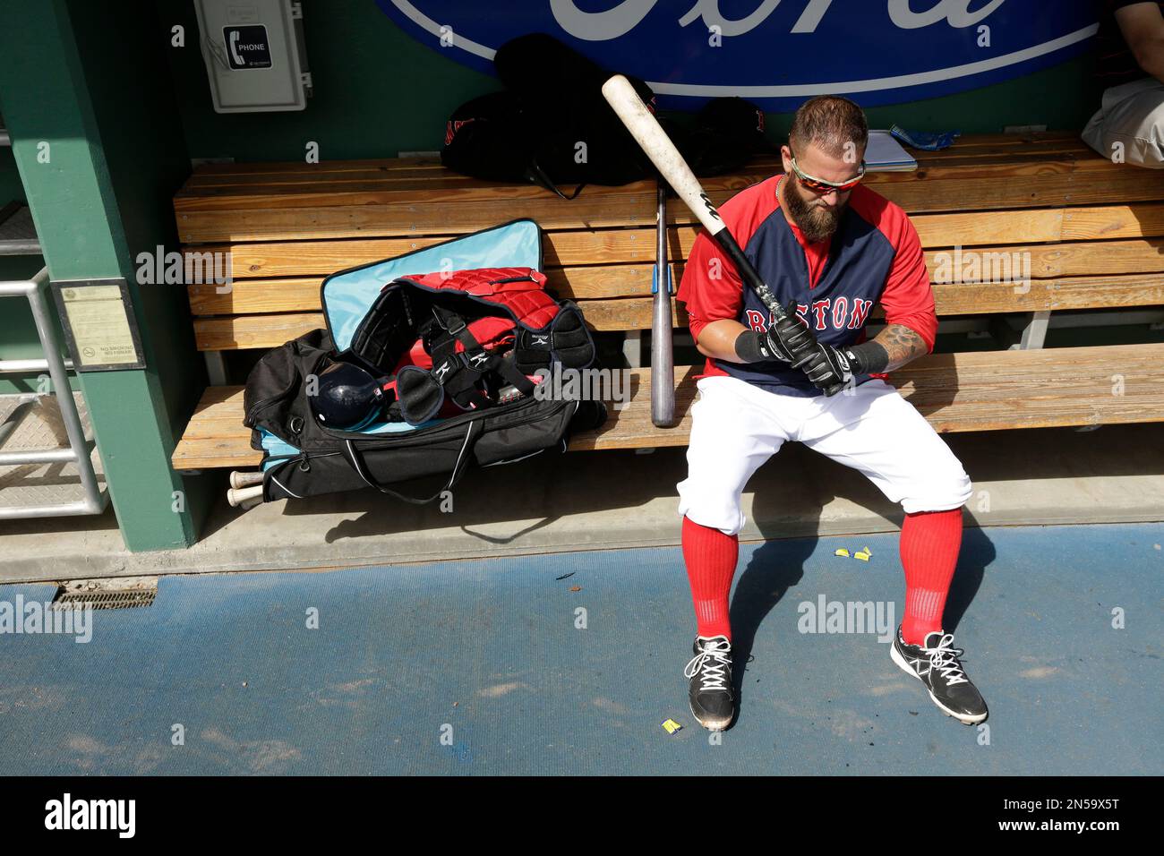 Boston Red Sox first baseman Mike Napoli holds a bat in the dugout ...