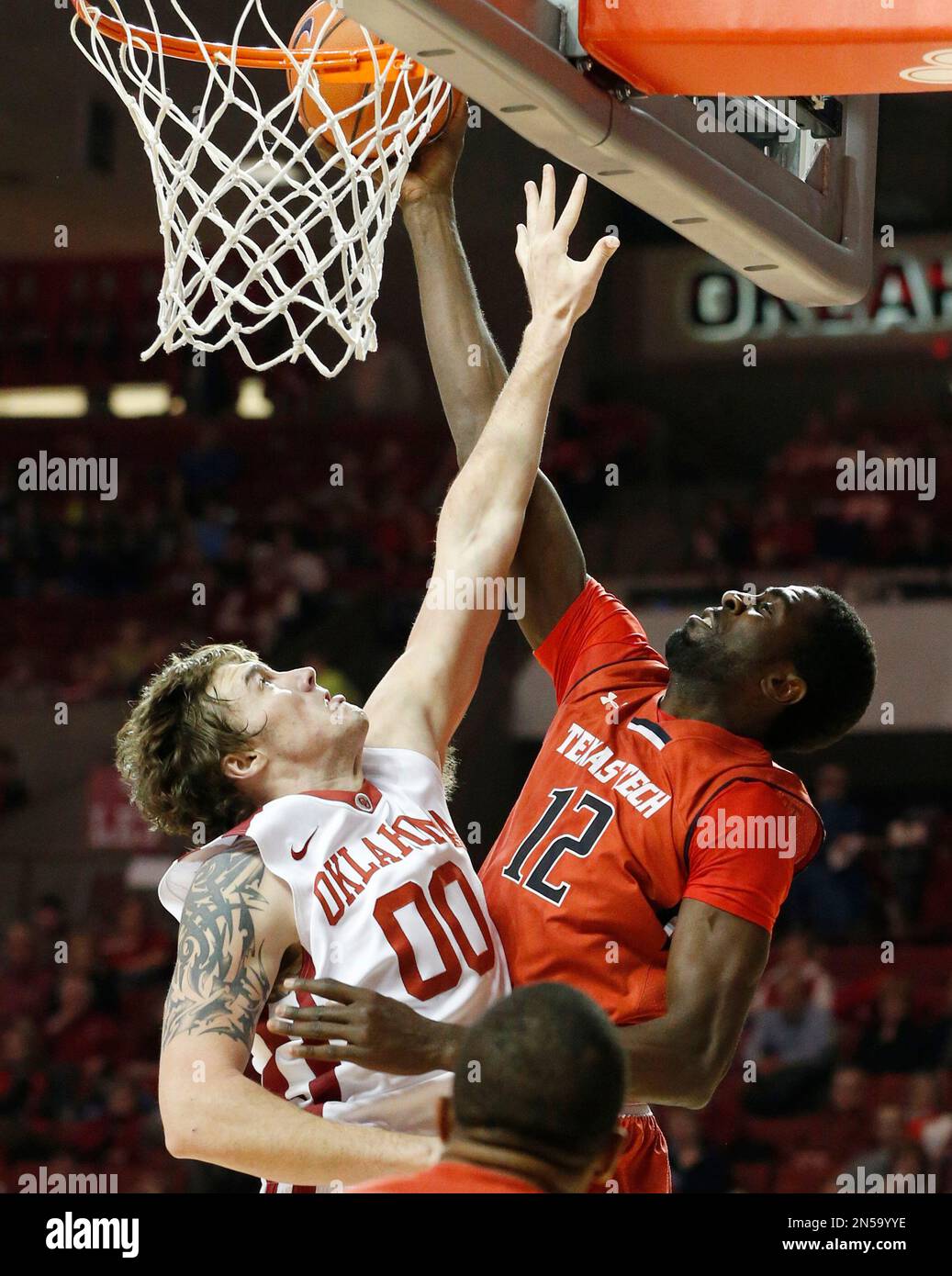 Oklahoma forward Ryan Spangler (00) defends as Texas Tech forward Kader ...