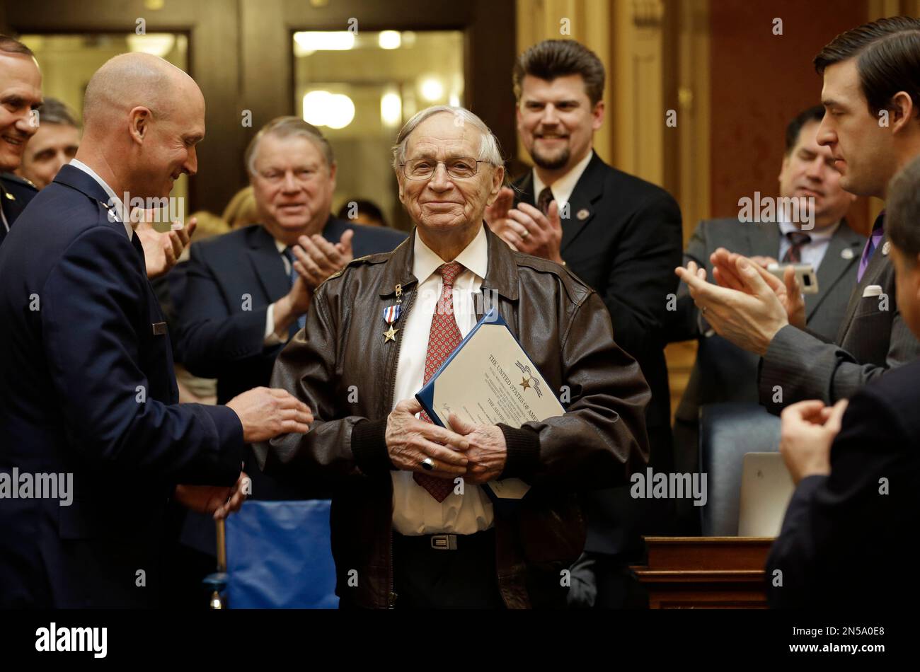 World War II Air Force veteran, Ernest Merle Hancock, center, smiles as ...