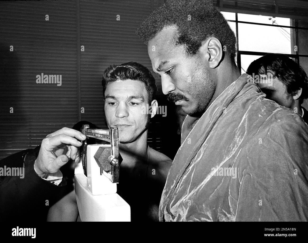 World welterweight champion Jose Napoles of Mexico stands on the scale for weigh-in prior to the ...