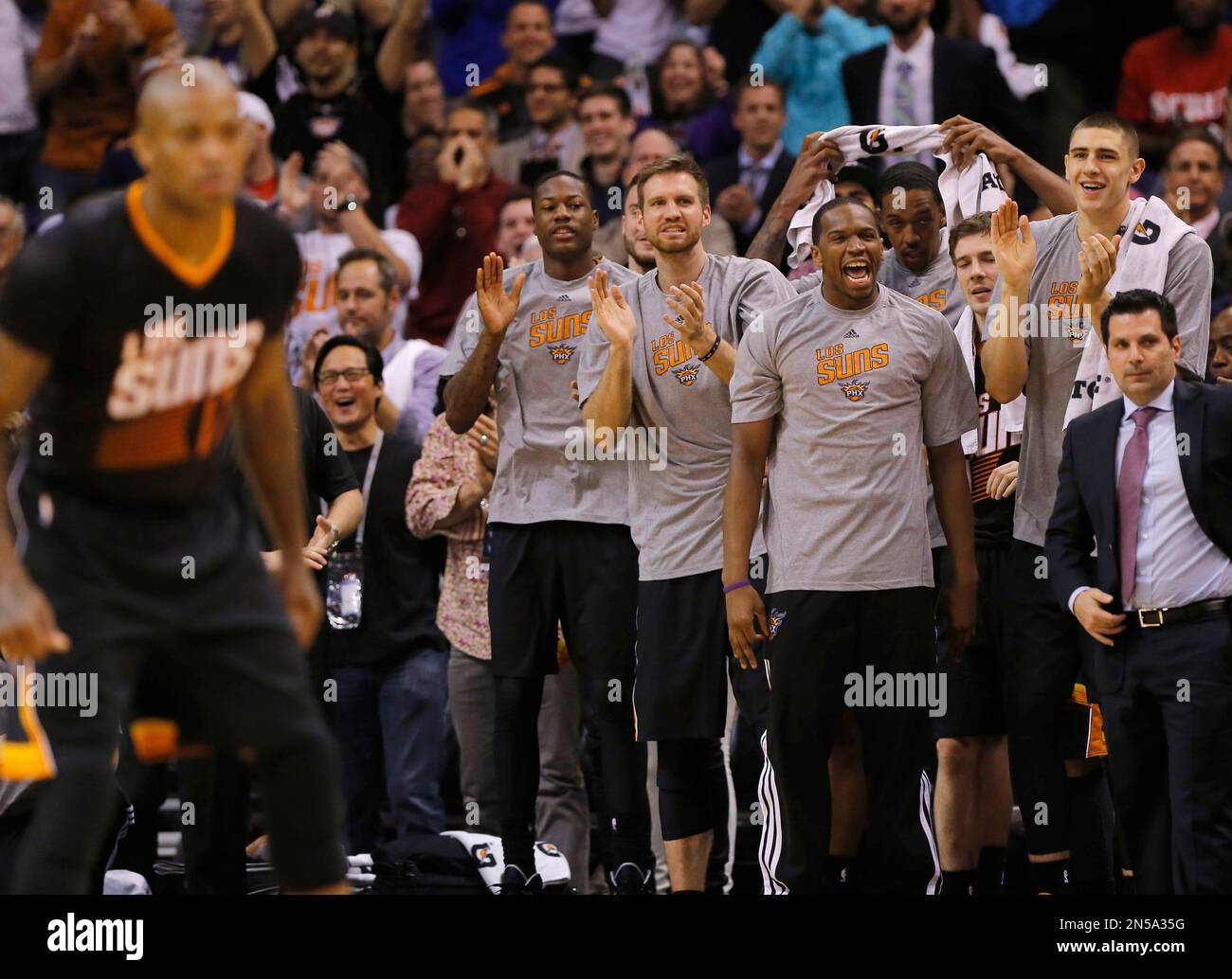 The Phoenix Suns bench cheers during the second half of an NBA ...
