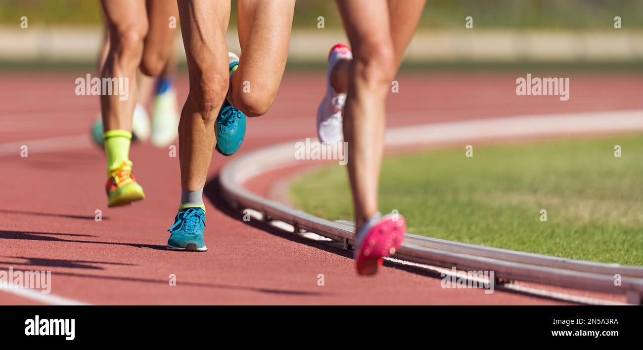 Athletics people running on the track field.Running a race on a track ...