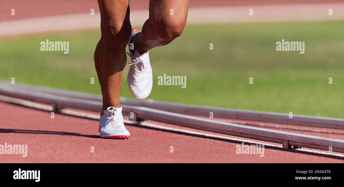 Athletic man running on track, racing down the track Stock Photo - Alamy