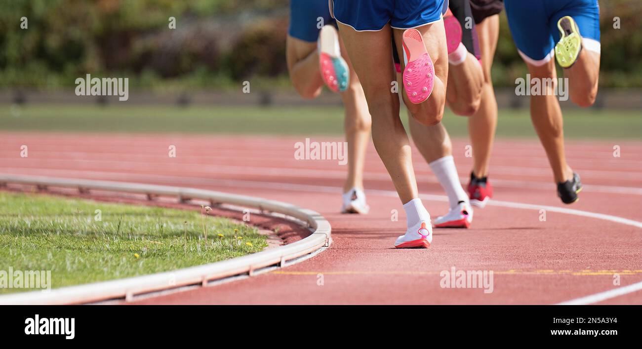 Athletics people running on the track field. Running a race on a track ...