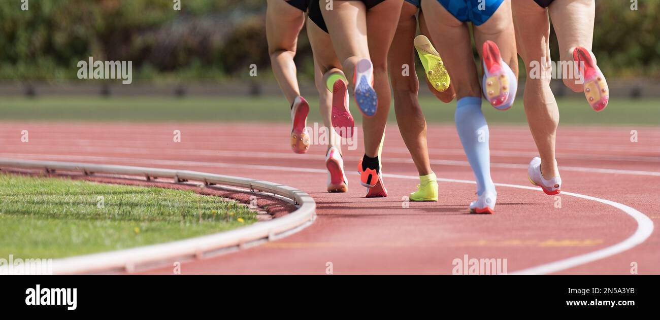 Athletics people running on the track field.Running a race on a track ...