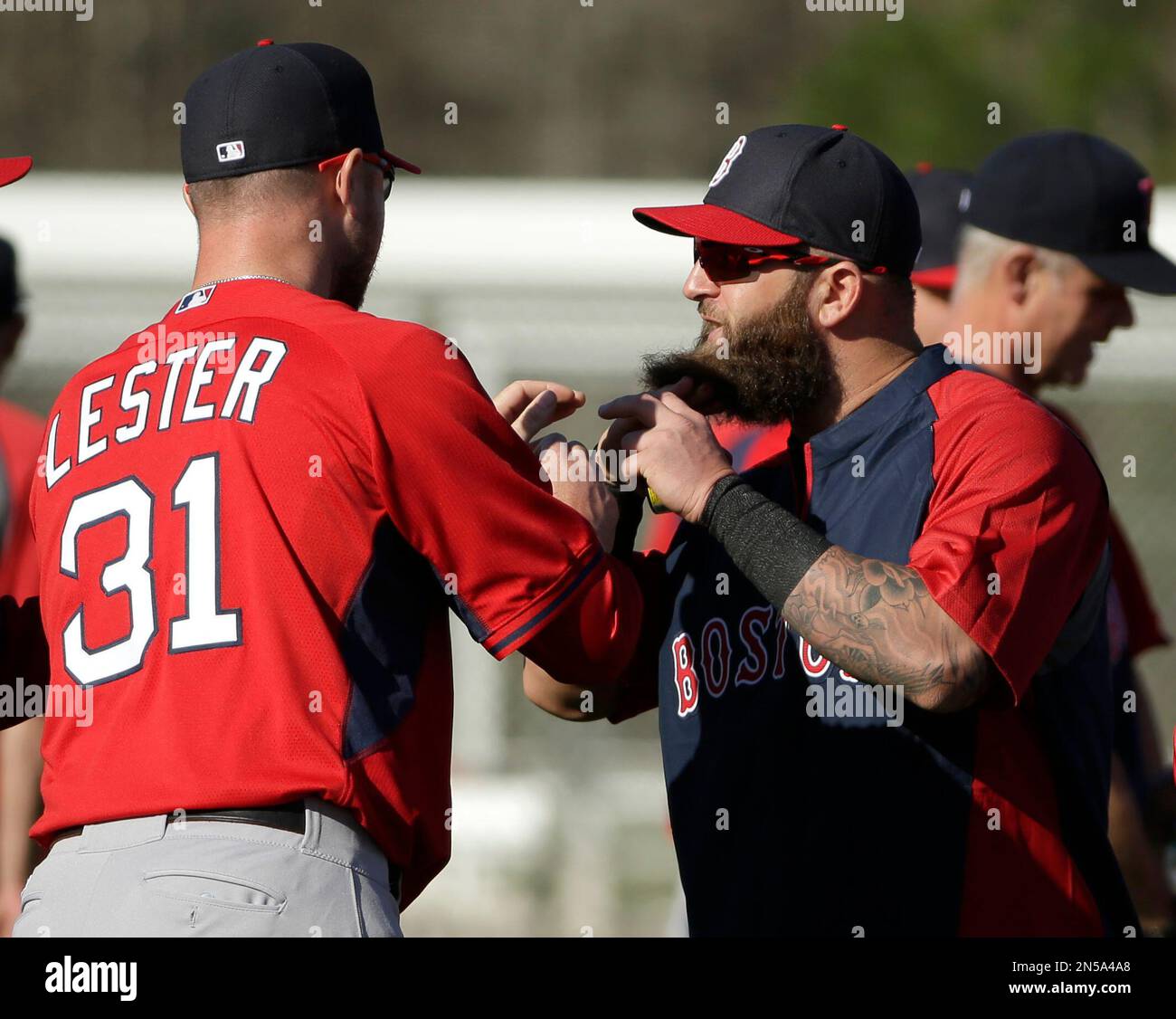 Boston Red Sox first baseman Mike Napoli, right, shows his beard to ...