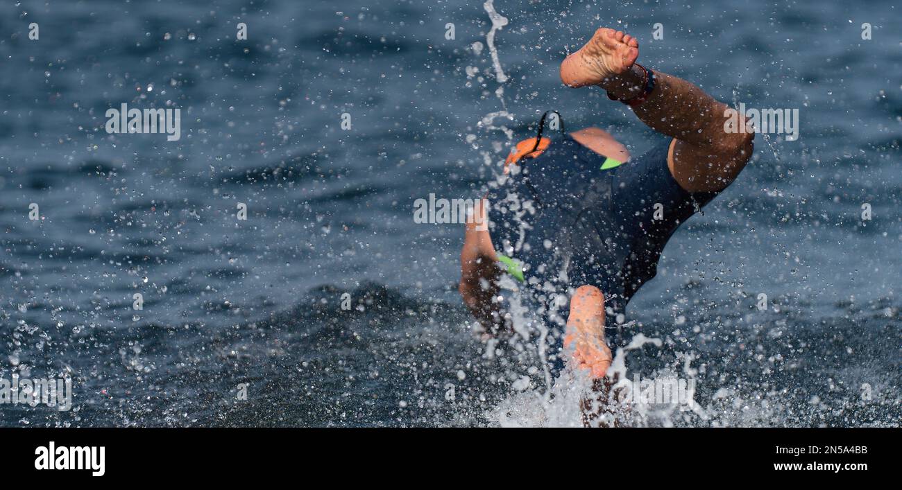 Swimmer at the start, jump flight into the ocean Stock Photo - Alamy