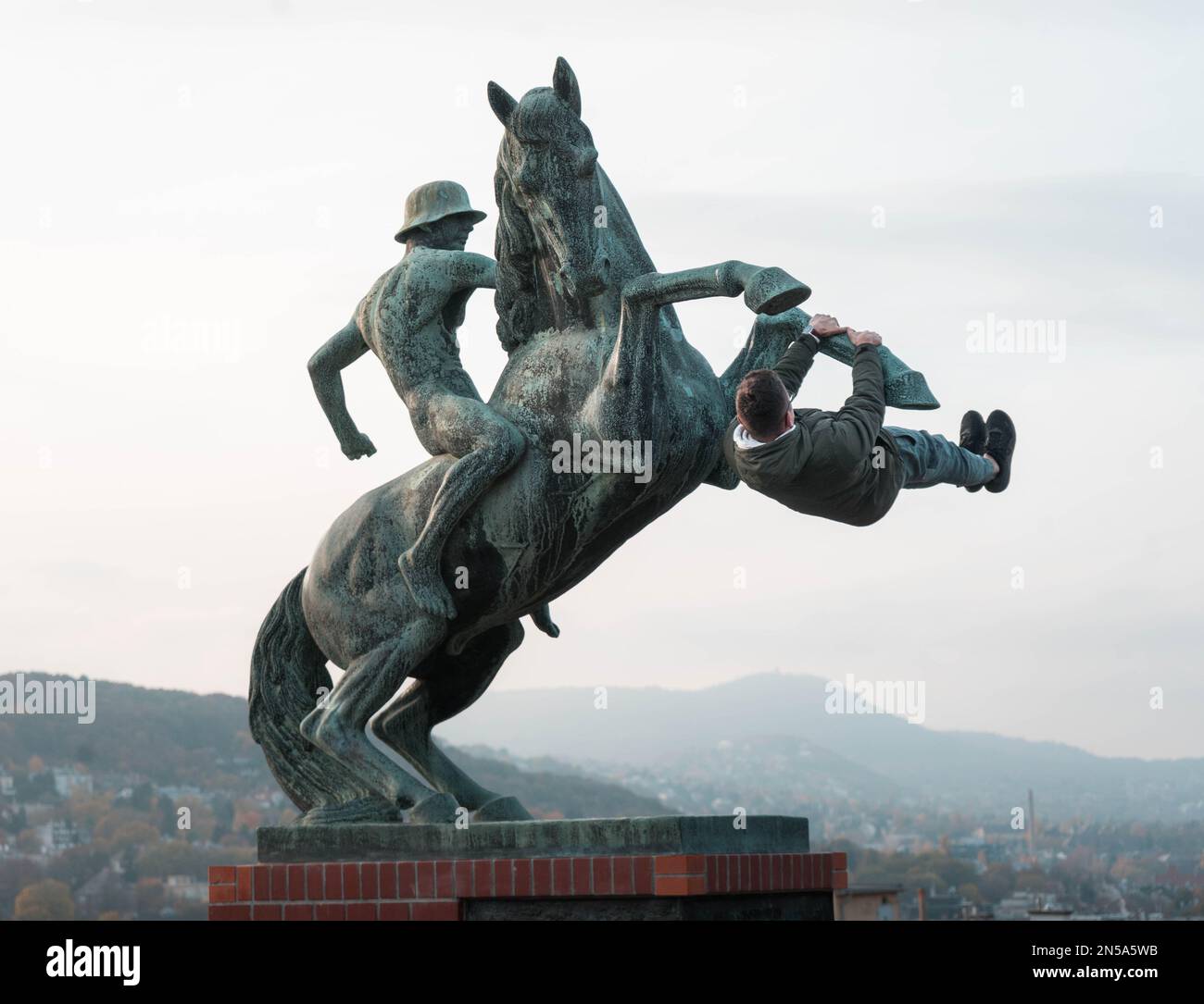 A closeup of a man hanging from the horse's leg of the Memorial WWI ...