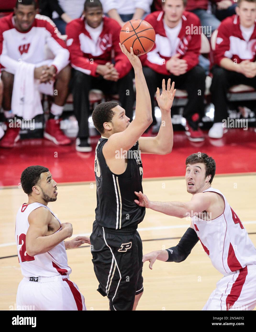 Purdue's A.J. Hammons shoots between Wisconsin's Traevon Jackson, left ...