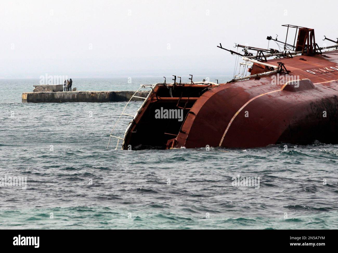People look at the scuttled decommissioned Russian vessel "Ochakov" as ...