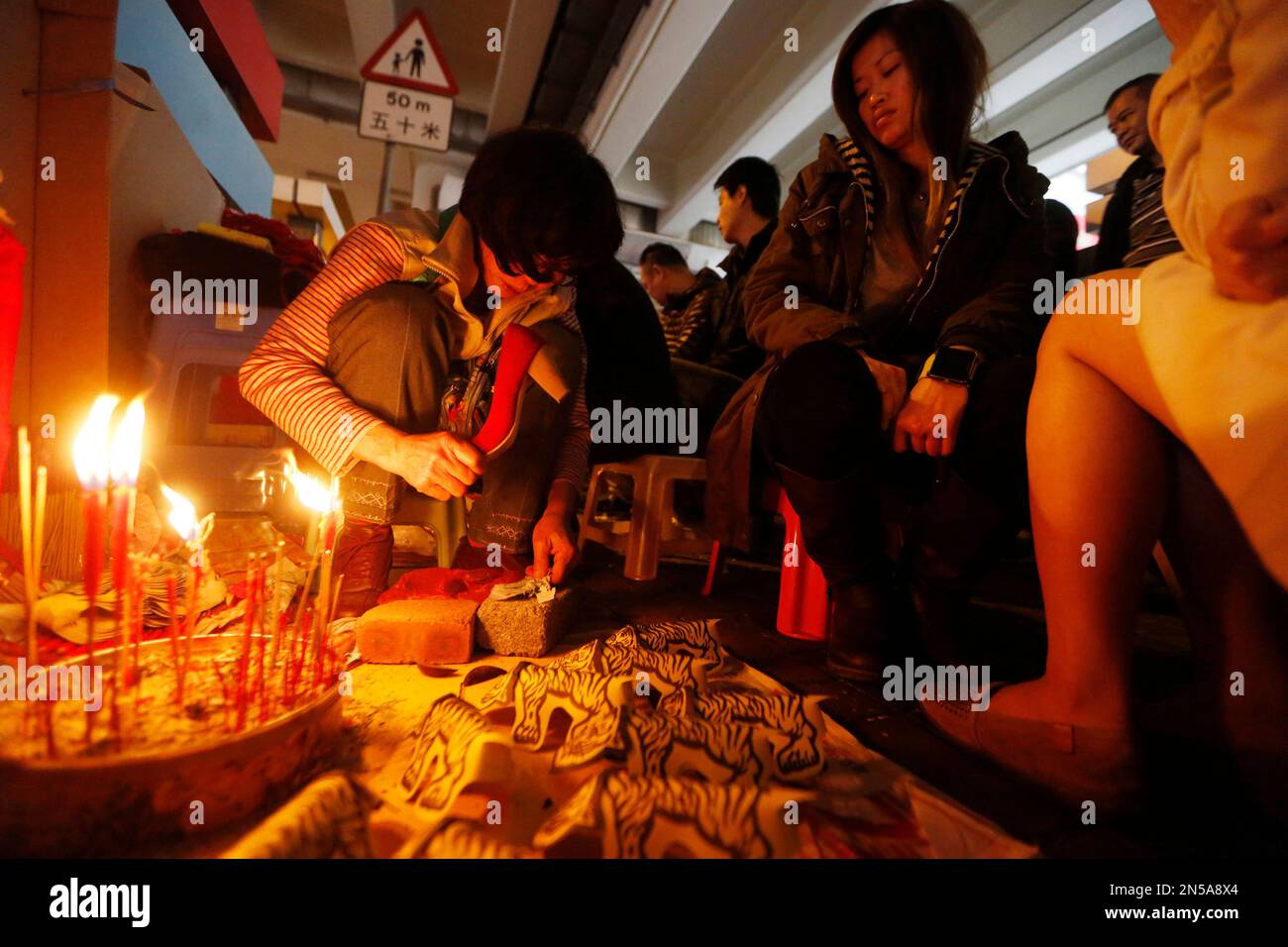 Believers, right, look at an elderly woman using a high-heeled shoe to ...