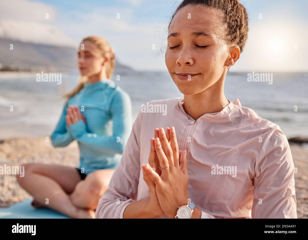 Yoga, meditation and woman friends on a beach together for mental ...