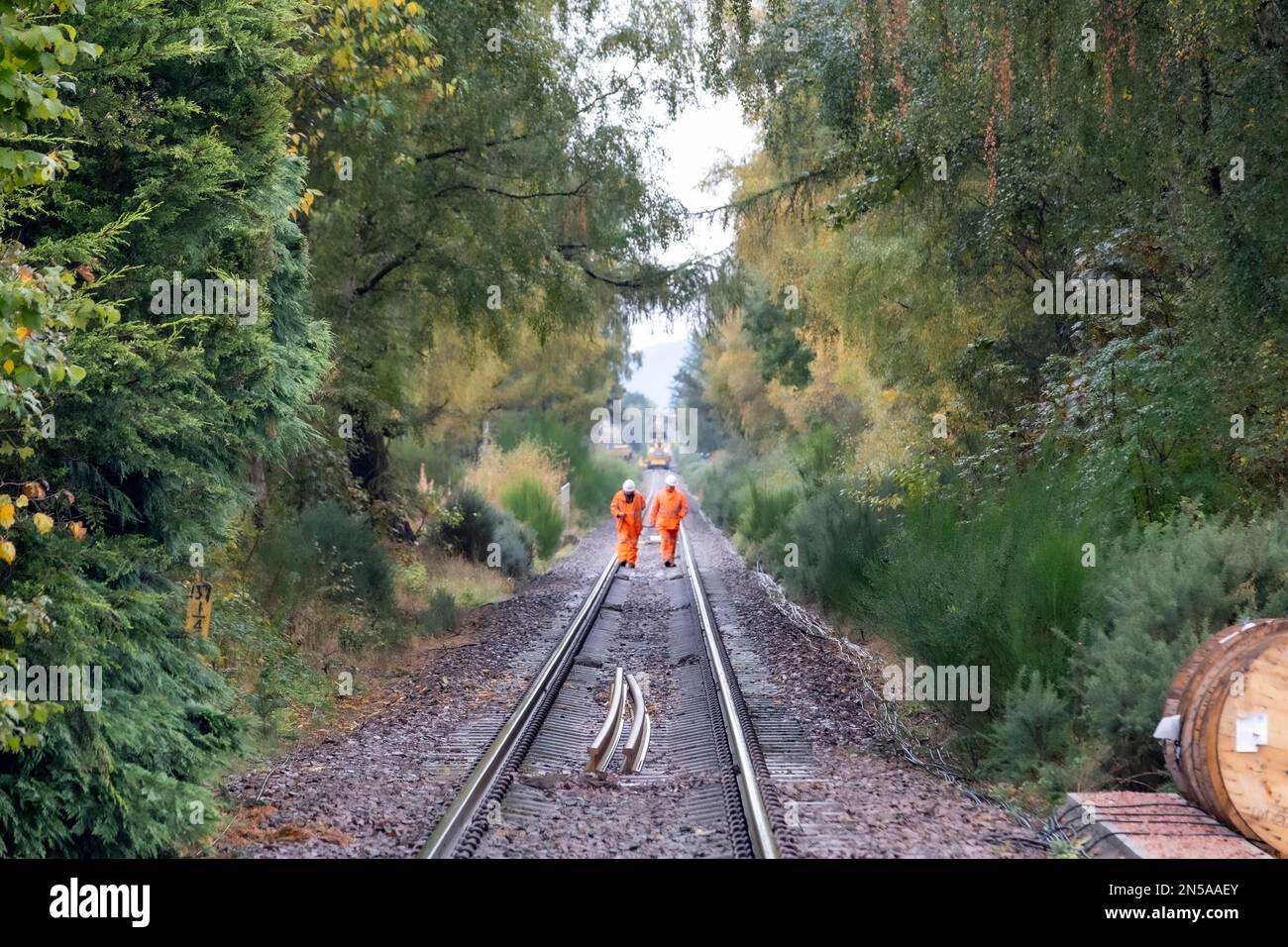 Railway workers building new railway and knocking down bridges Stock ...