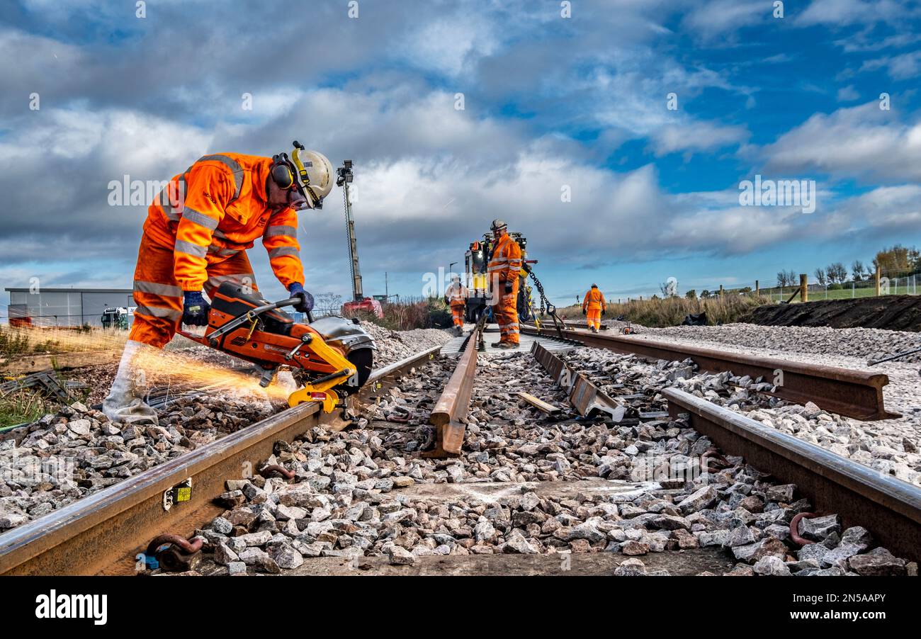 Railway workers building new railway and knocking down bridges Stock ...