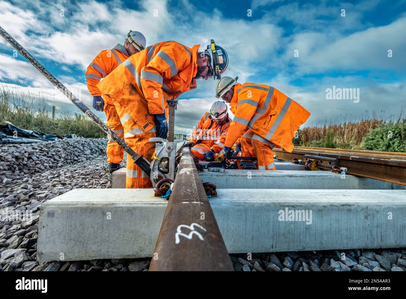 Railway workers building new railway and knocking down bridges Stock ...