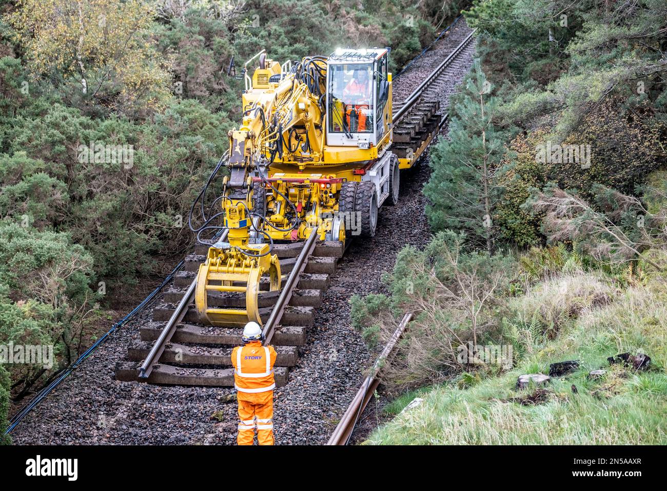 Railway workers building new railway and knocking down bridges Stock ...