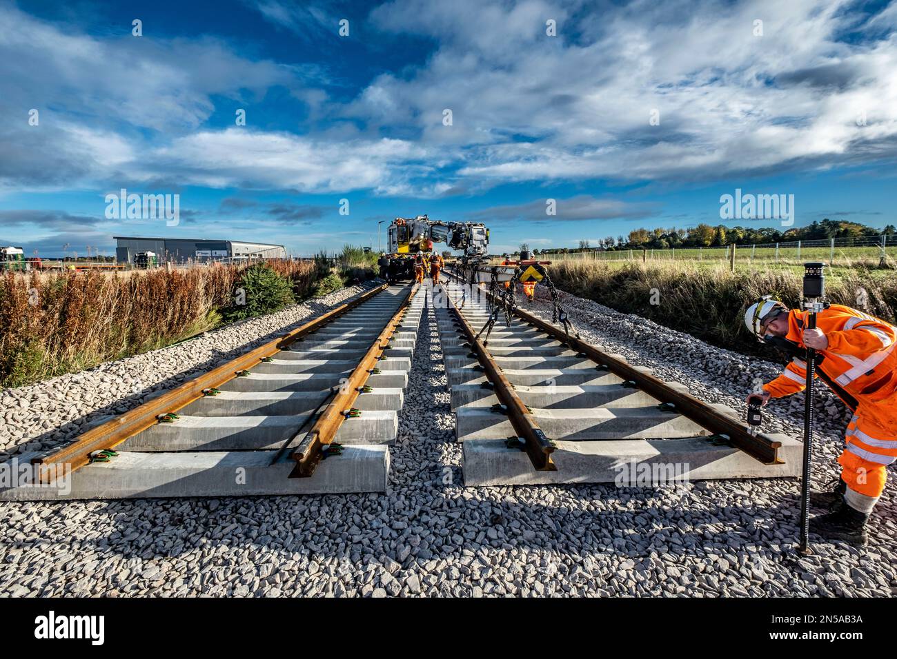 Railway workers building new railway and knocking down bridges Stock ...