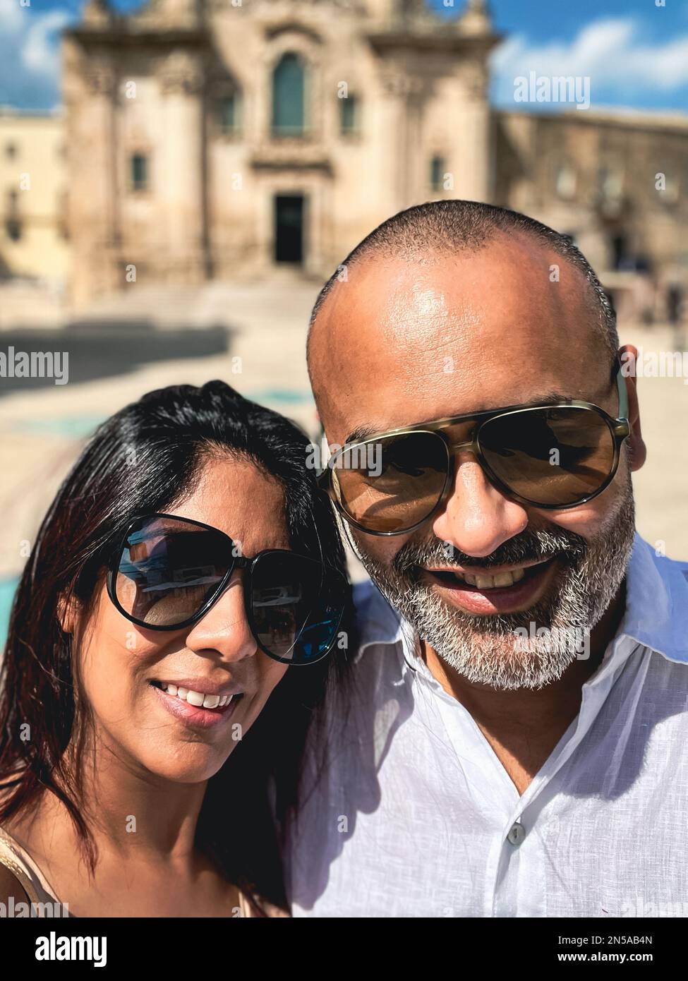Indian ethnicity couple taking a selfie on vacation in the Italian town ...