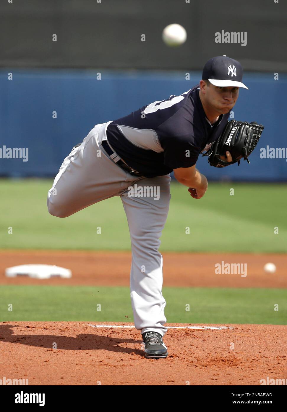 New York Yankees pitcher Adam Warren delivers a warm-up throw in the ...