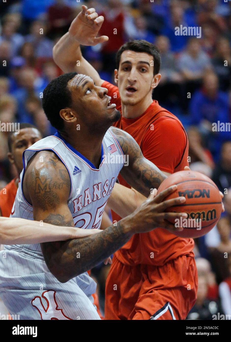 Kansas forward Tarik Black (25) is fouled while covered by Texas Tech ...
