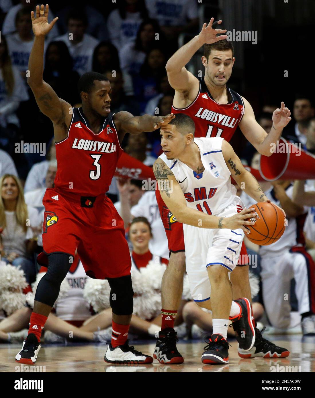 Louisville's Chris Jones (3) and Luke Hancock (11) pressure SMU's Nic ...