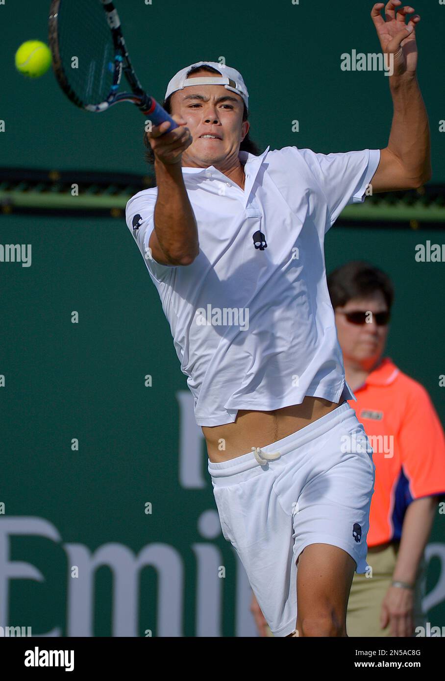 Taro Daniel, of Japan, returns a shot against Alex Kuznetsov during a qualifying match at the ...