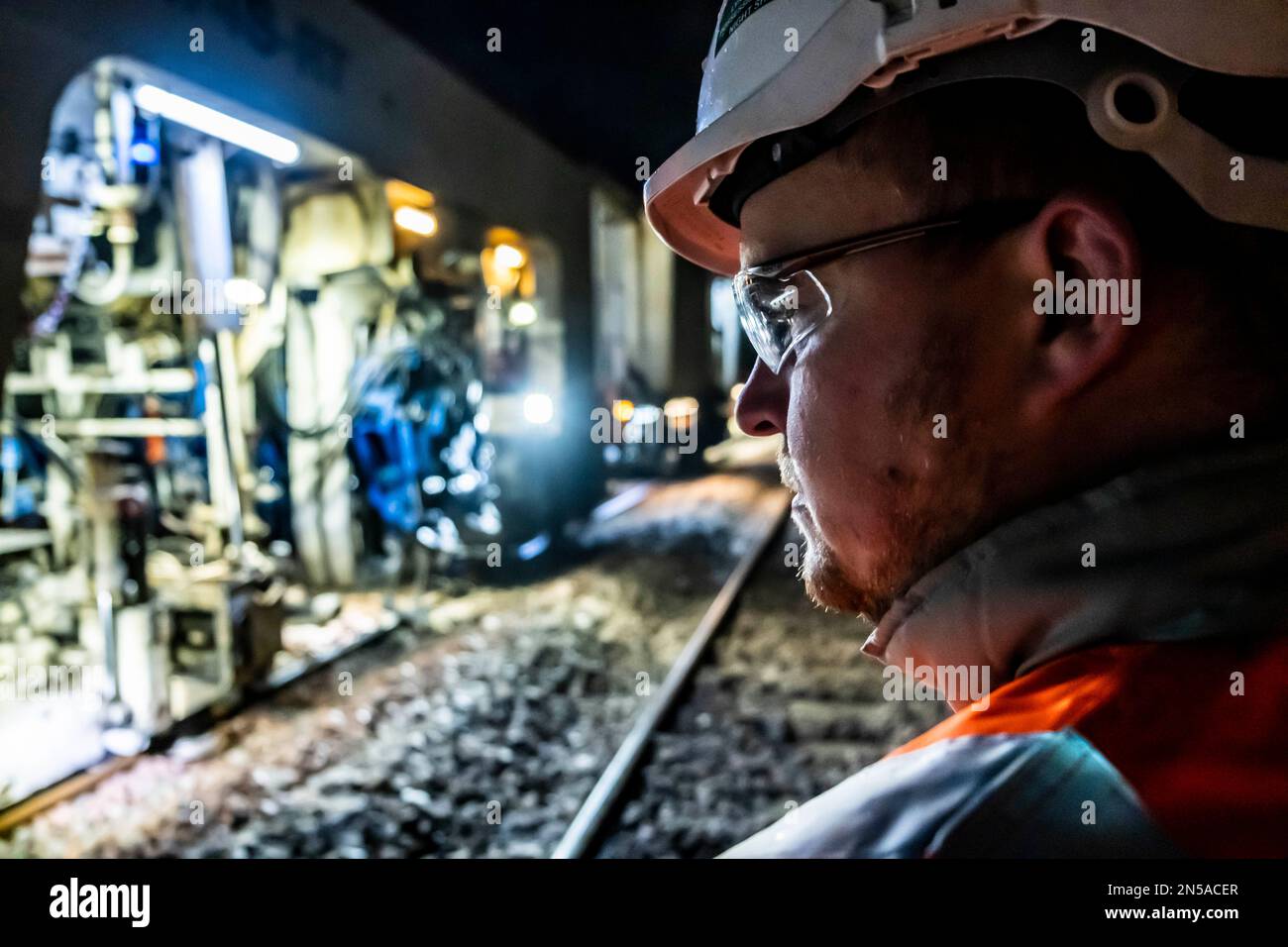 Railway workers building new railway and knocking down bridges Stock ...