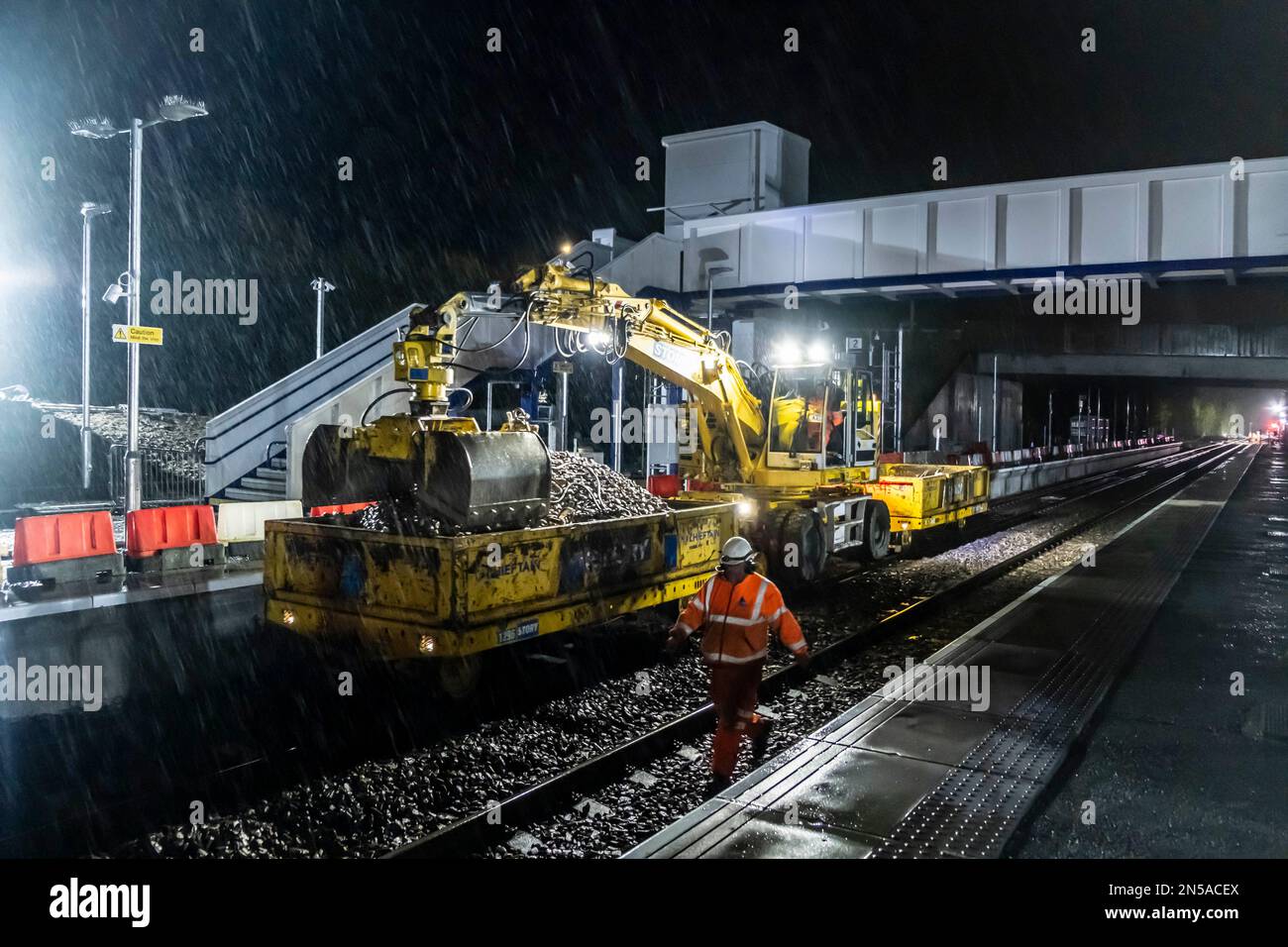 Railway workers building new railway and knocking down bridges Stock ...