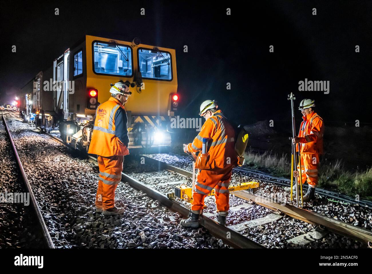 Railway workers building new railway and knocking down bridges Stock ...