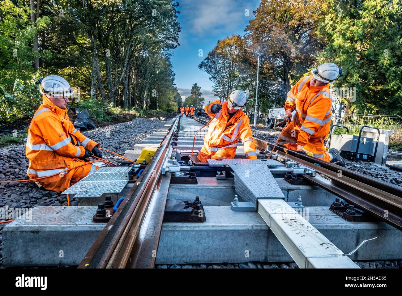 Railway workers building new railway and knocking down bridges Stock ...