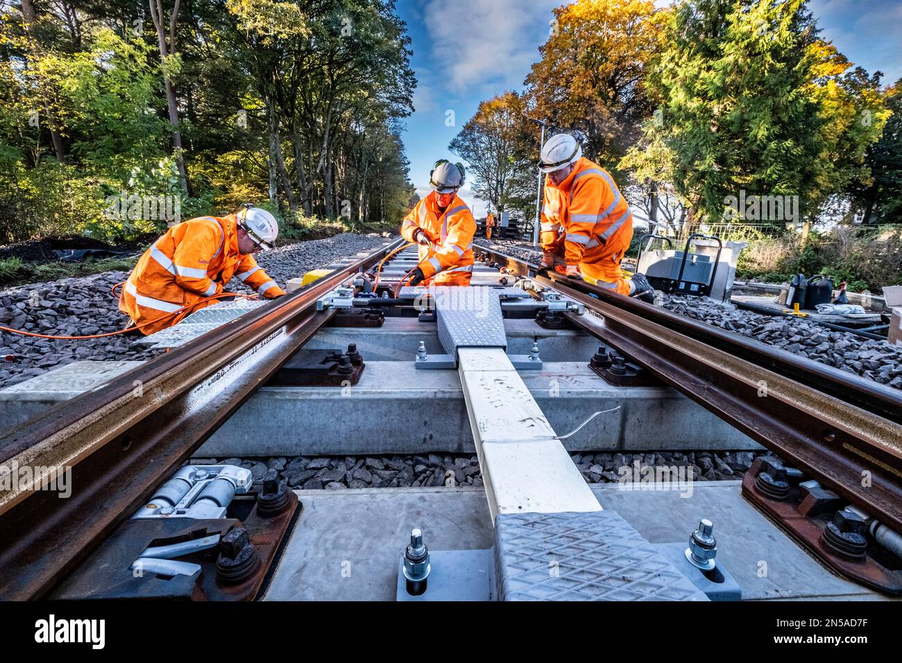 Railway workers building new railway and knocking down bridges Stock ...