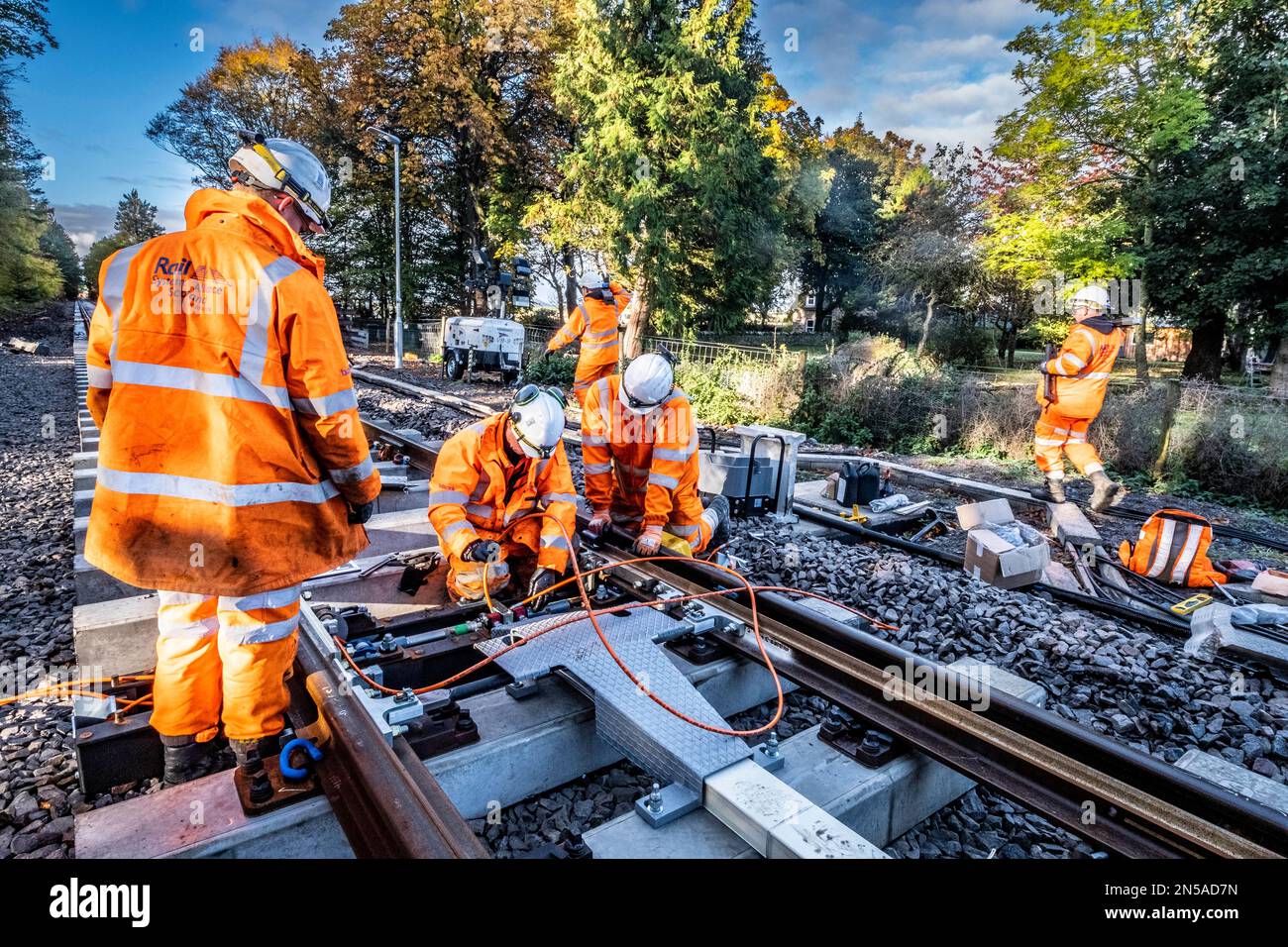 Railway workers building new railway and knocking down bridges Stock ...