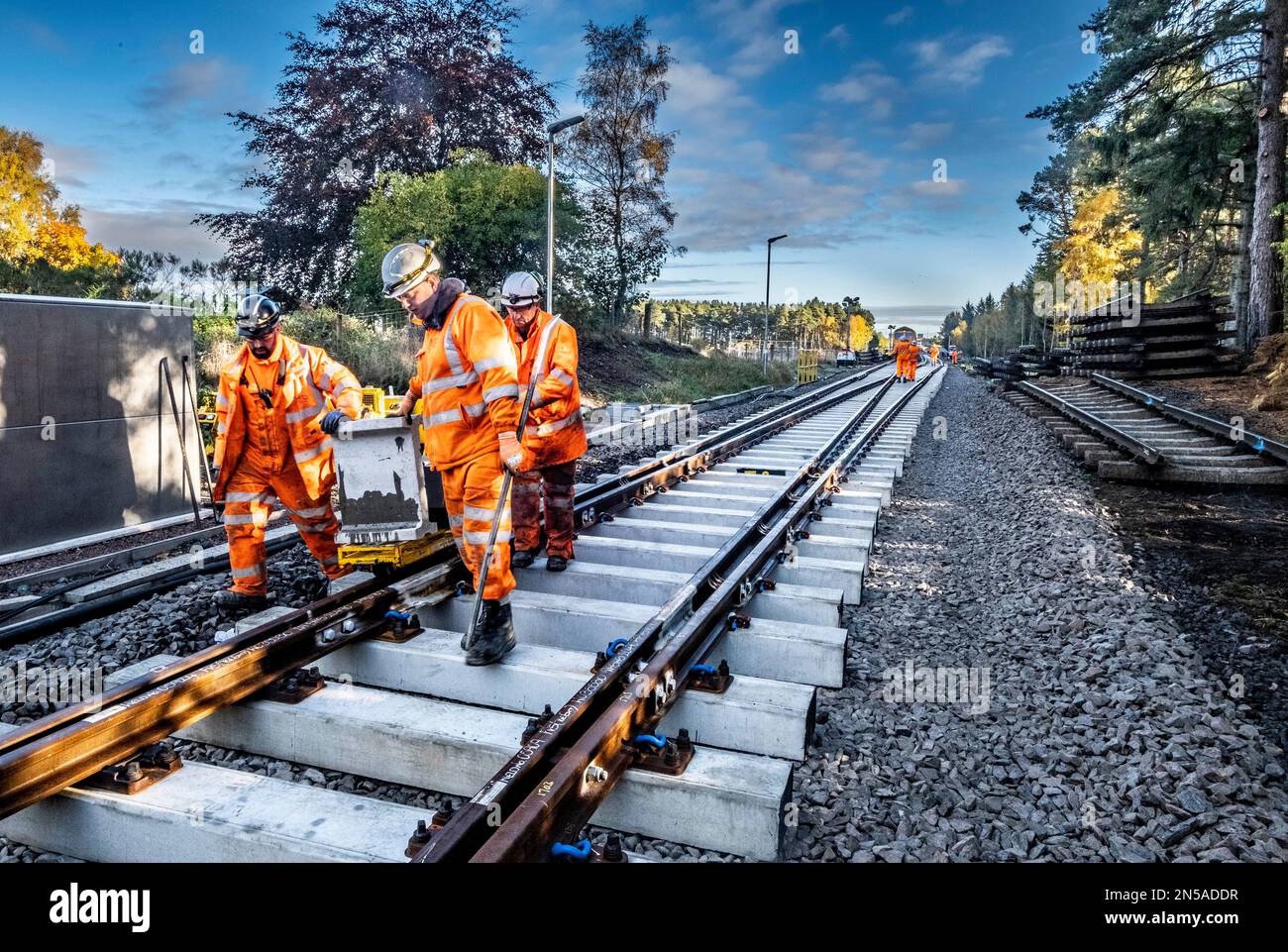 Railway workers building new railway and knocking down bridges Stock ...