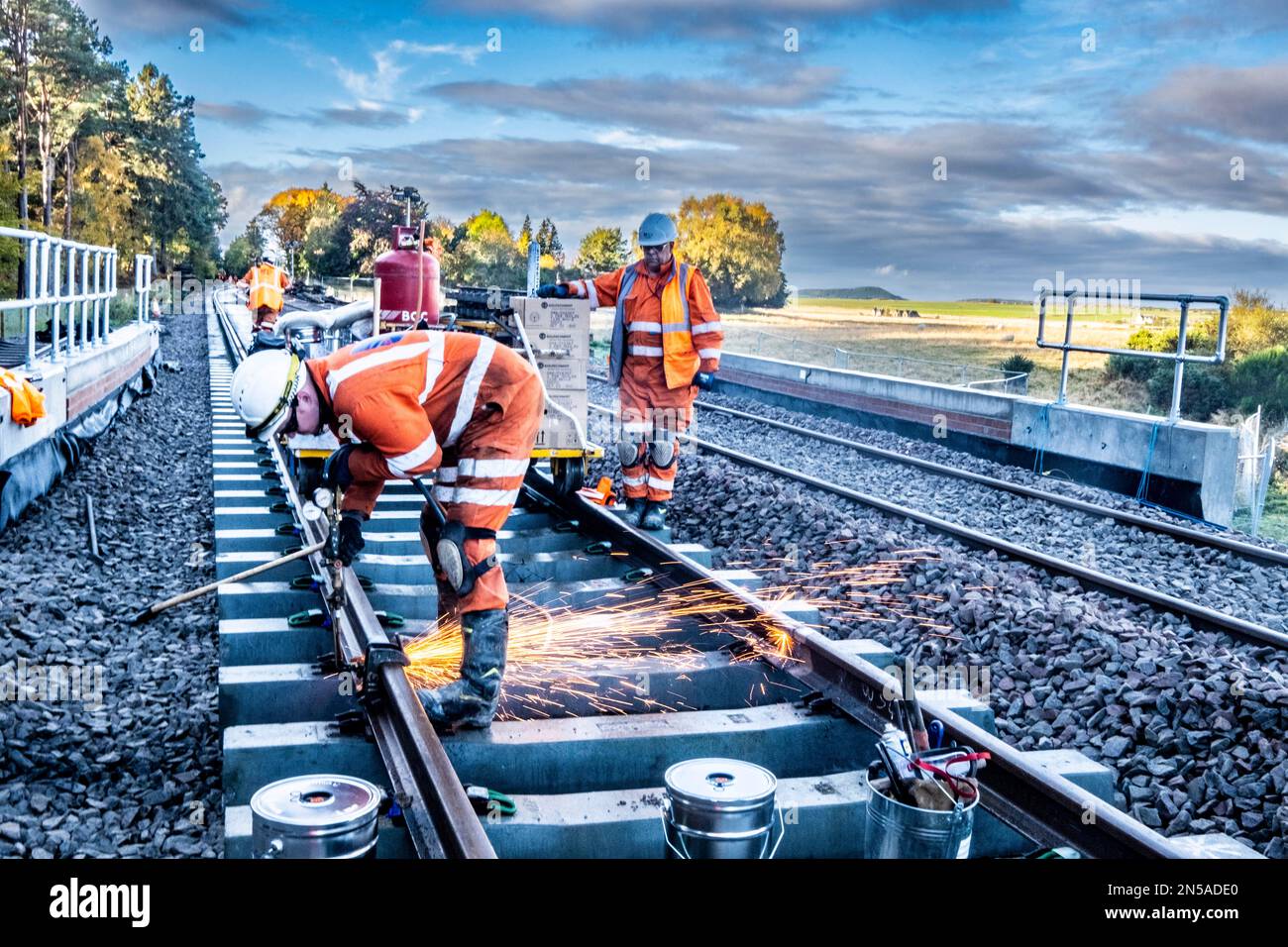 Railway workers building new railway and knocking down bridges Stock ...