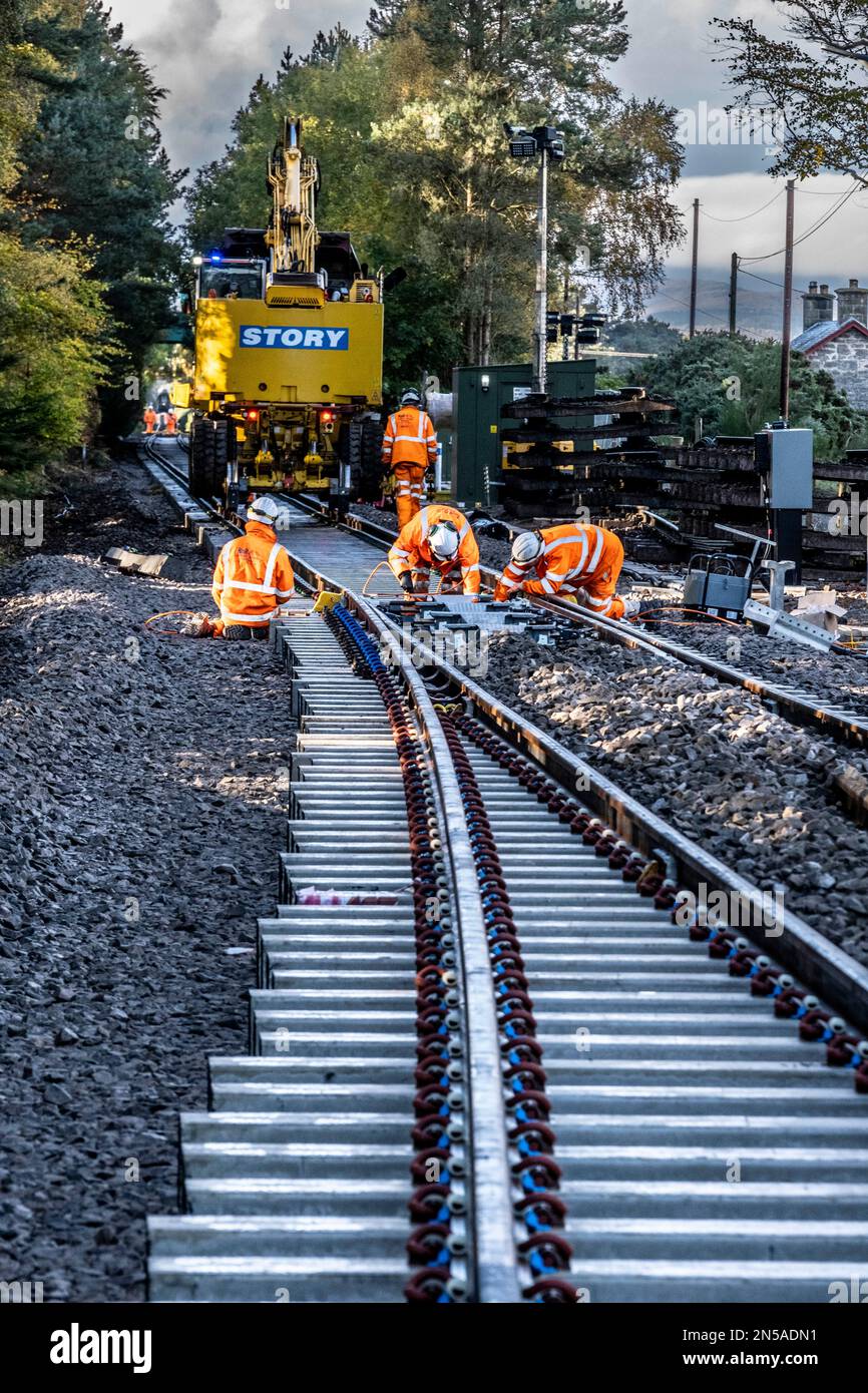 Railway workers building new railway and knocking down bridges Stock ...
