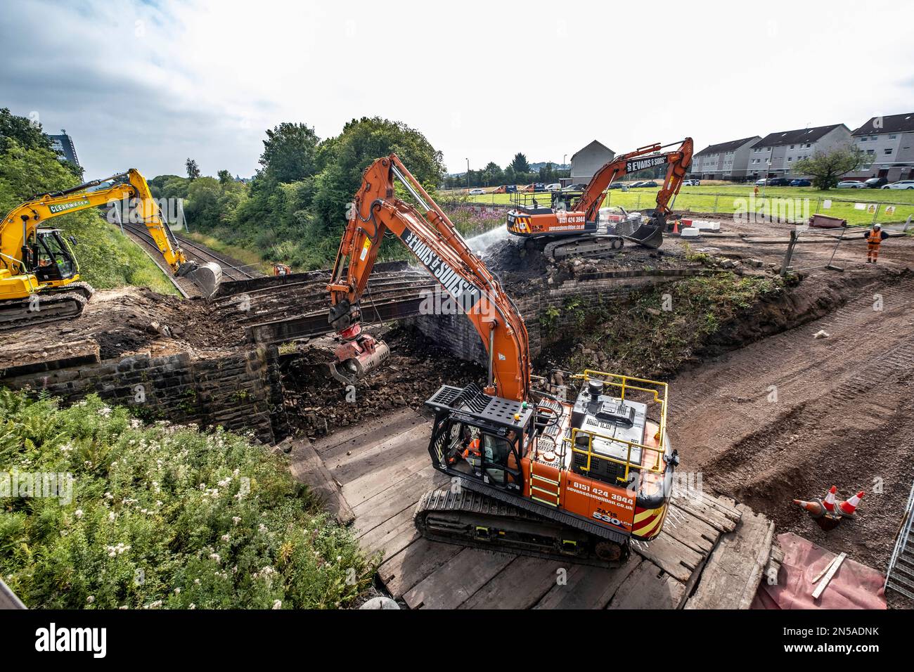 Railway workers building new railway and knocking down bridges Stock ...