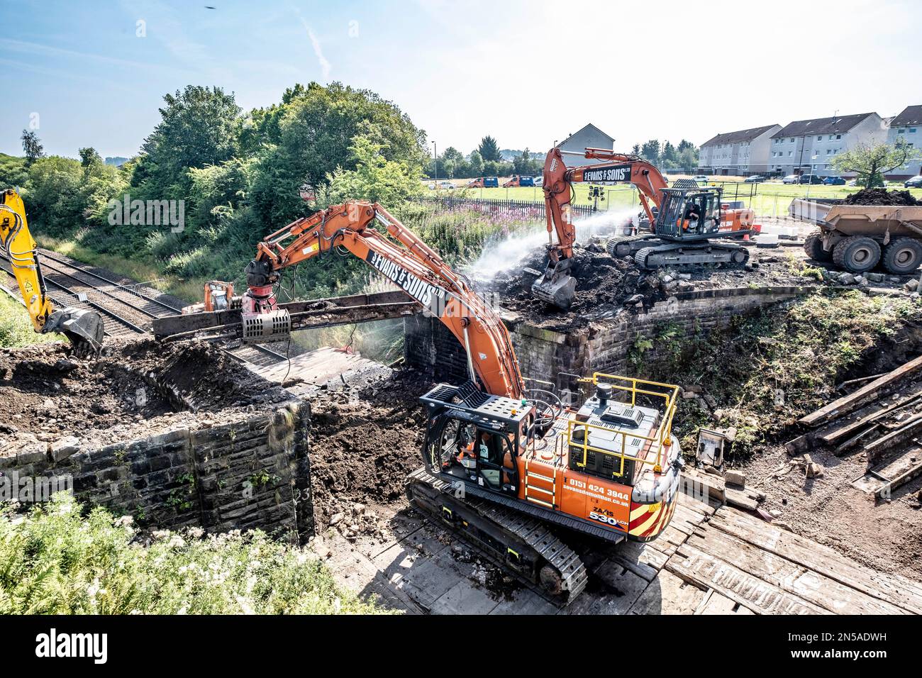 Railway workers building new railway and knocking down bridges Stock ...