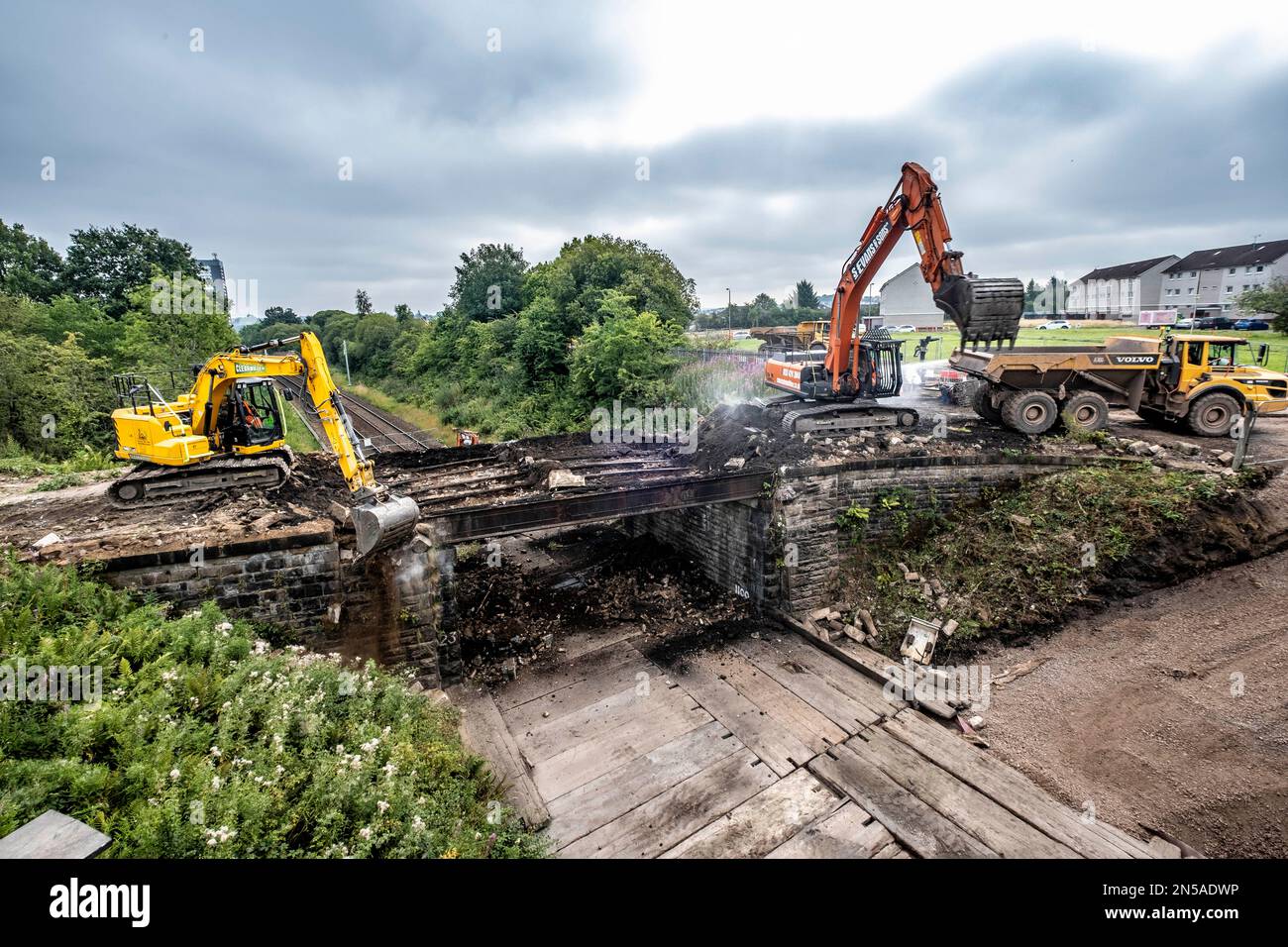 Railway workers building new railway and knocking down bridges Stock ...