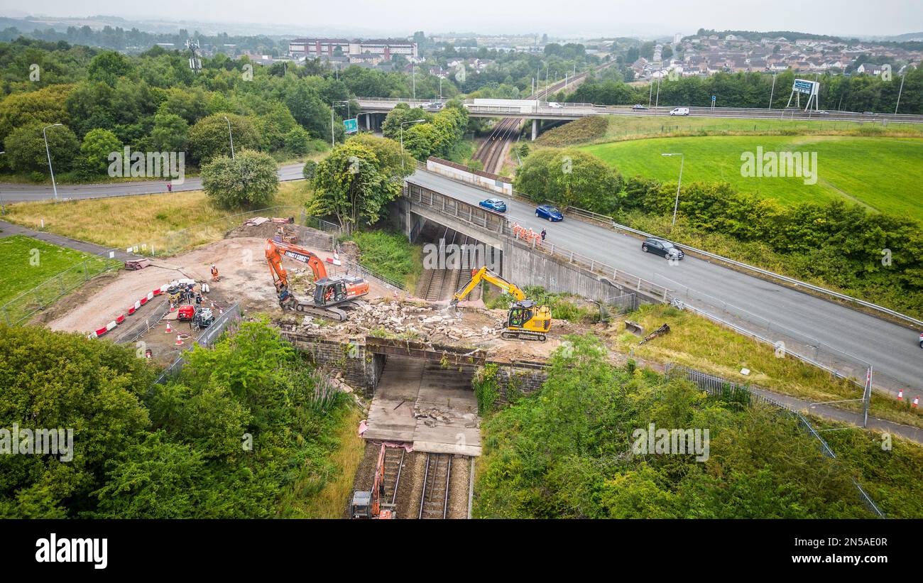 Railway workers building new railway and knocking down bridges Stock ...