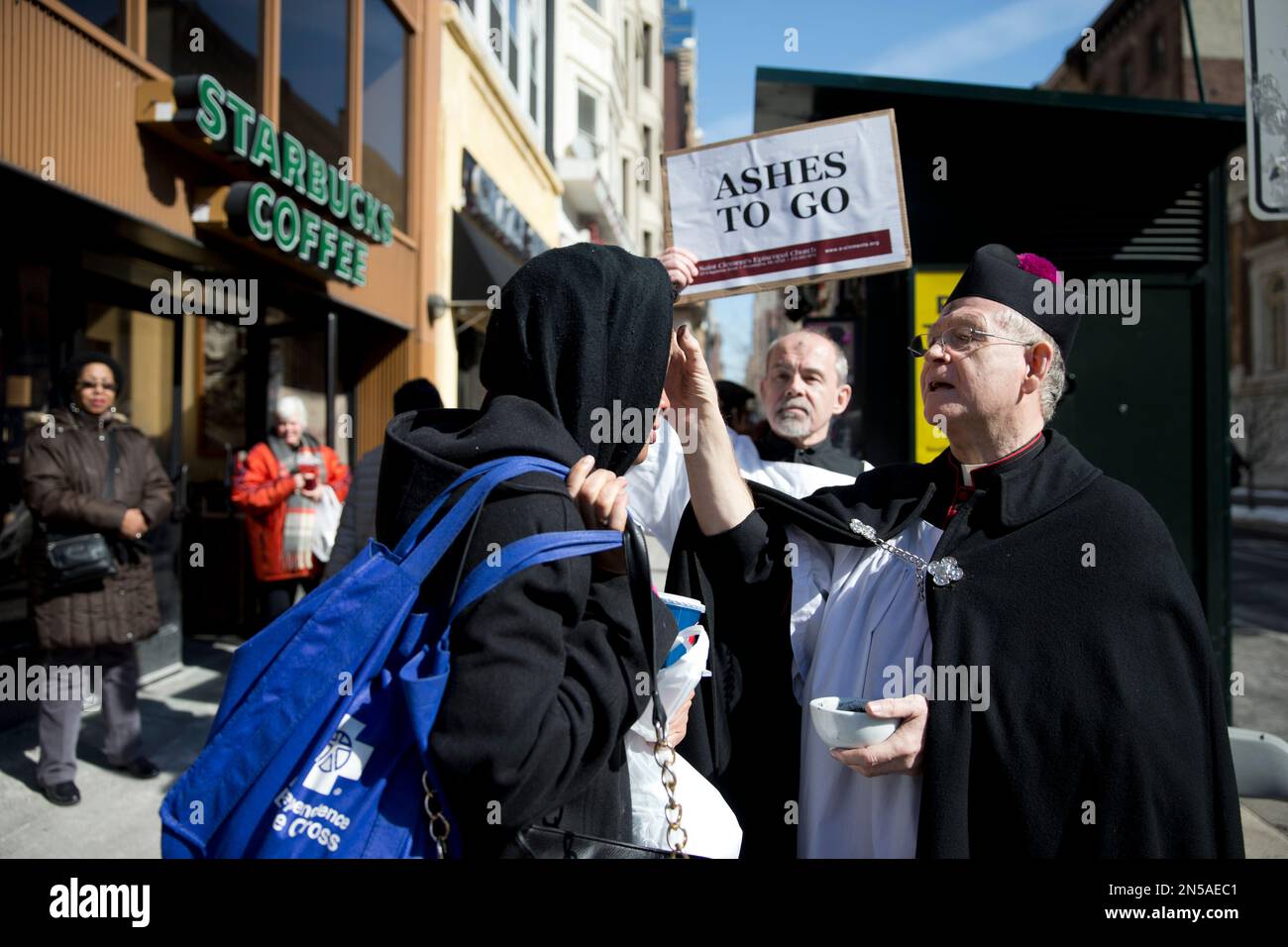 The Rev. Gordon Reid with Saint Clement's Episcopal Church places ash ...
