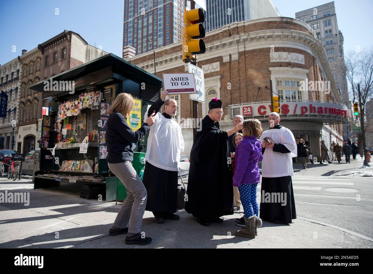 The Rev. Gordon Reid with Saint Clement's Episcopal Church places ash ...