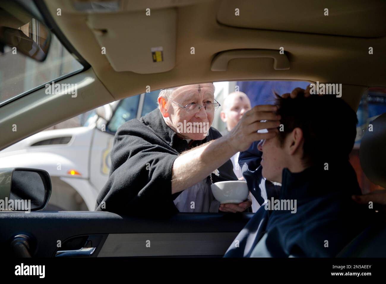 The Rev. Gordon Reid with Saint Clement's Episcopal Church, places ash ...