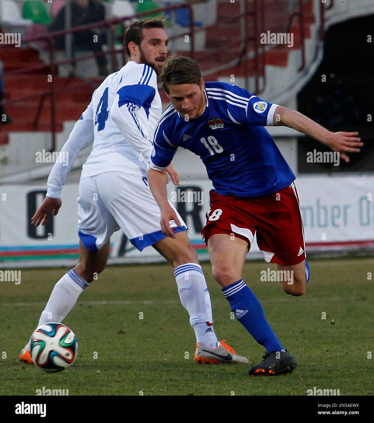 Georgia's Guram Kashia, left, fights for the ball with Liechtenstein's ...