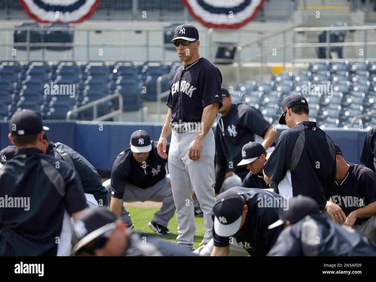 New York Yankees manager Joe Girardi, center, stands on the field while ...