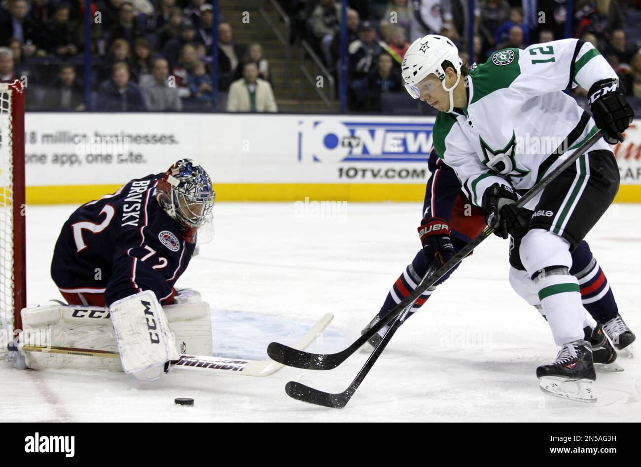 Columbus Blue Jackets goalie Sergi Bobrovsky, left, of Russia, stops a shot against Dallas Stars ...