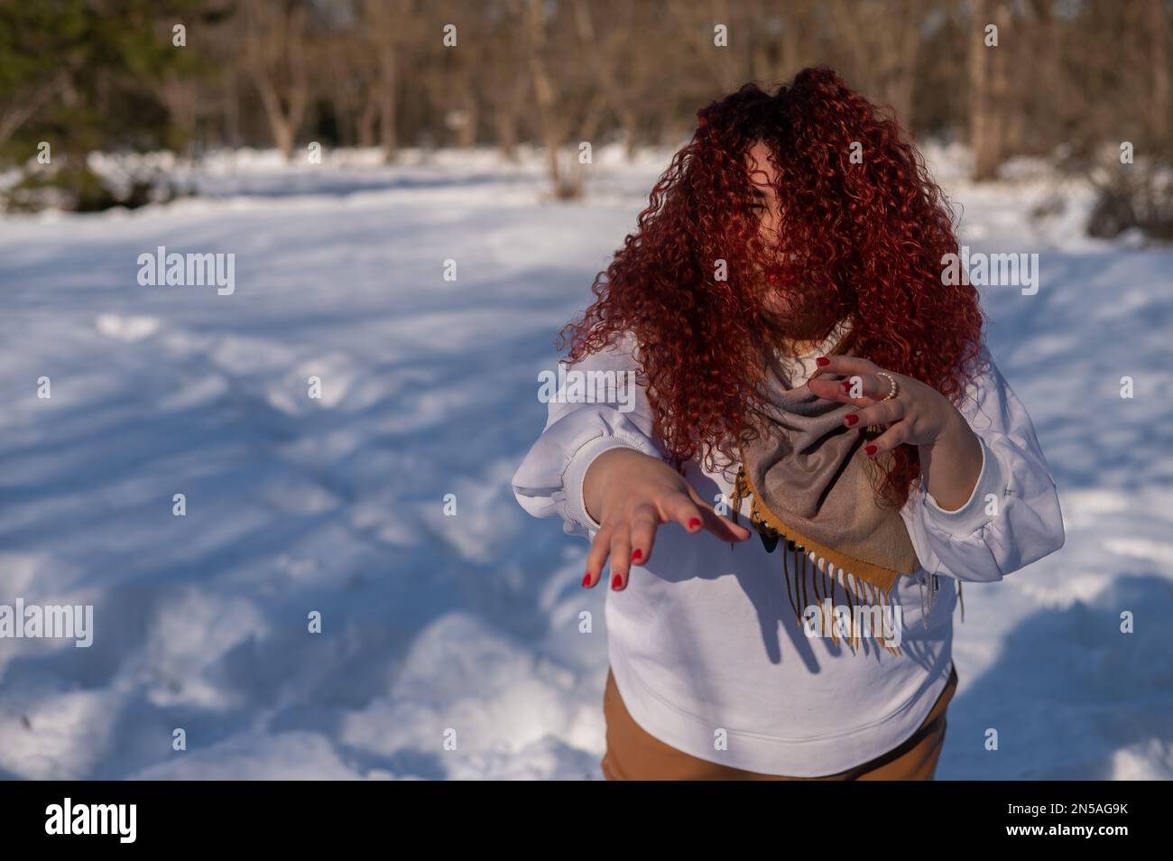The plump-cheeked woman threw her red hair over her face and held out ...