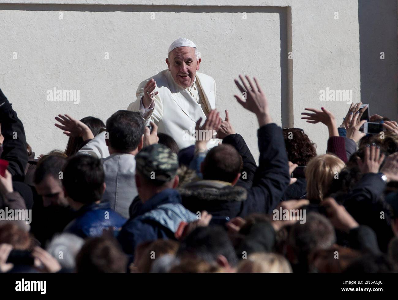Pope Francis greets the crowd as he arrives for his weekly general ...